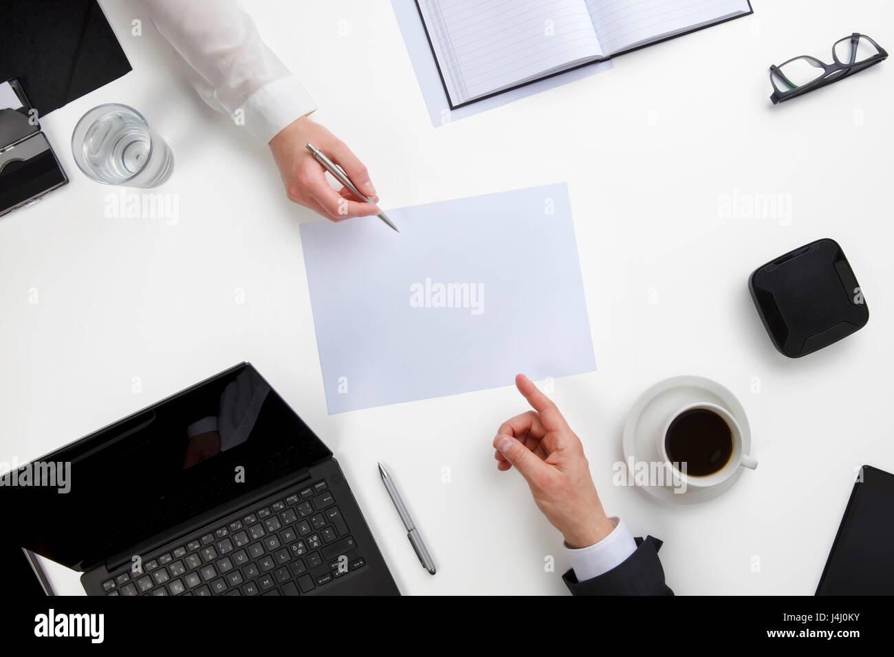 Business People Discussing Over Document At White Desk Stock Photo - Alamy