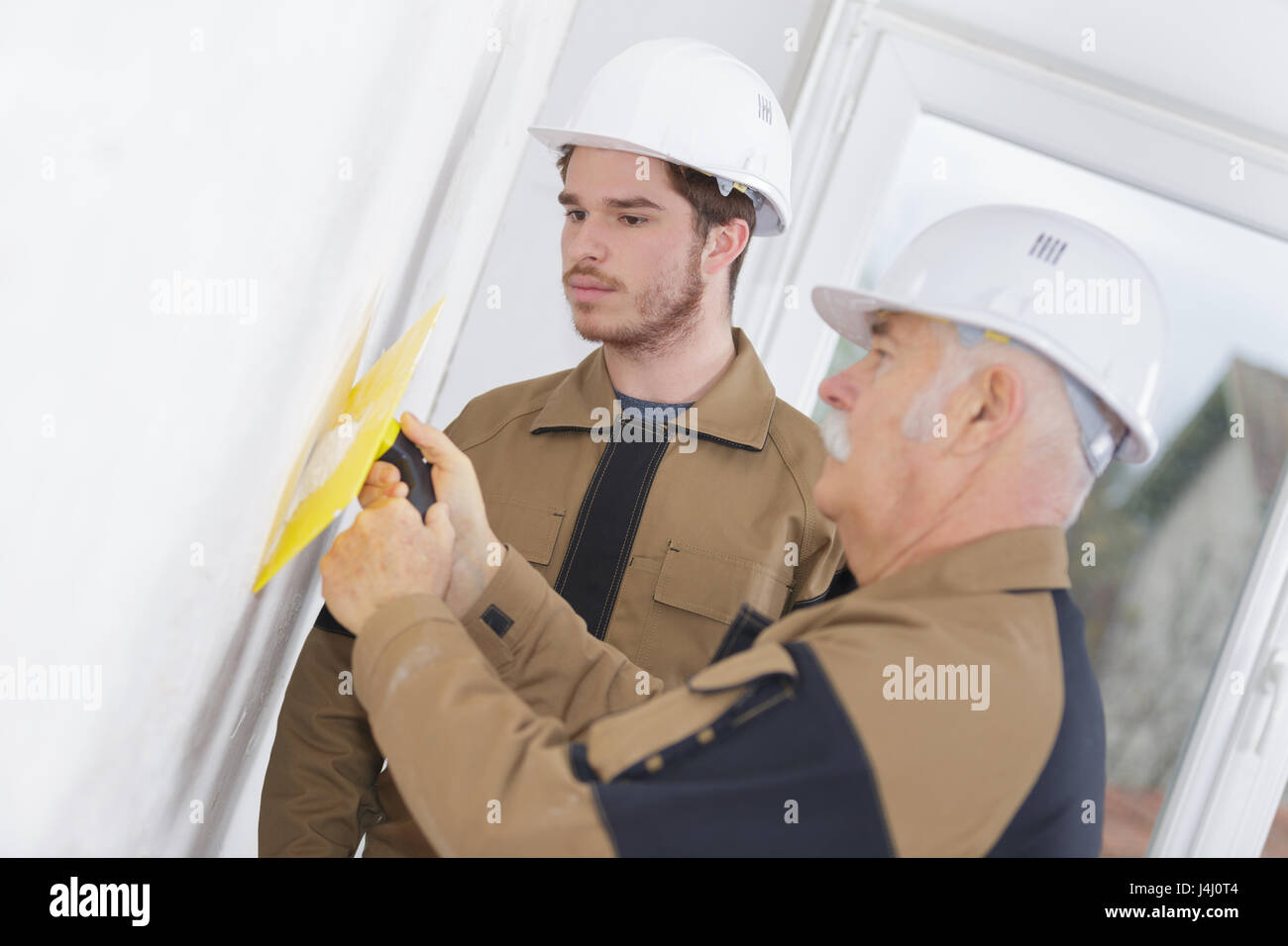 Man using trowel apply hi-res stock photography and images - Alamy
