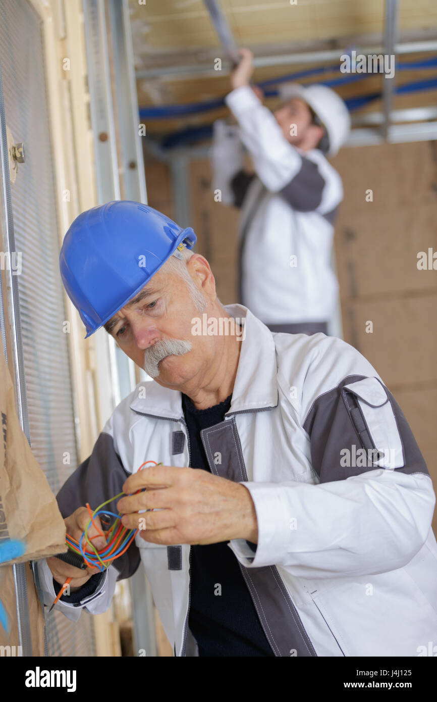 Senior electrician working on site Stock Photo - Alamy