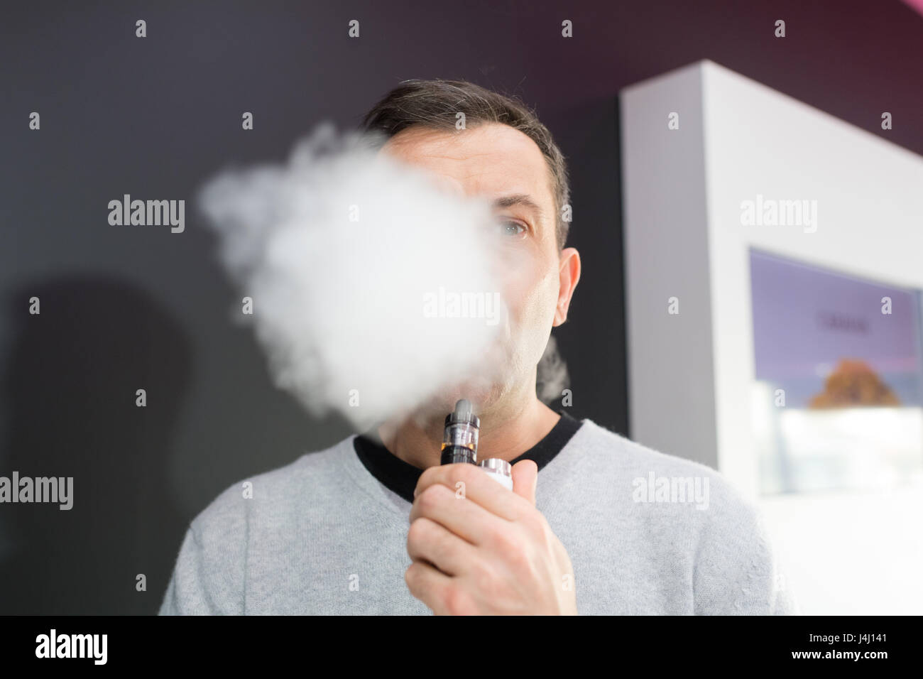 man obscured behind a cloud of vaporizer smoke Stock Photo - Alamy
