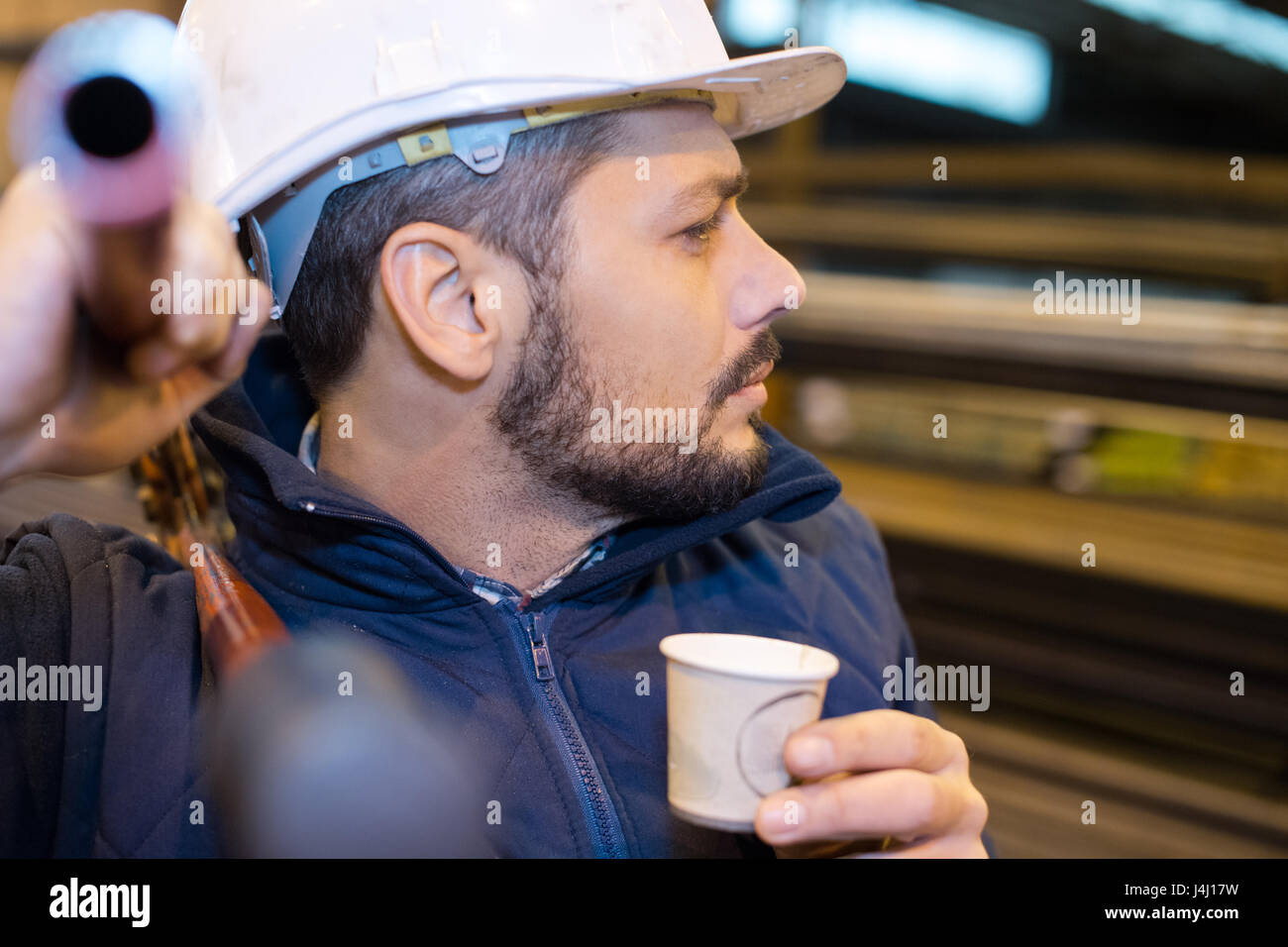 worker drinking coffee from vending machine Stock Photo - Alamy