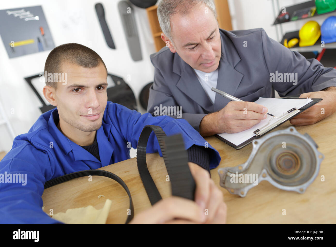 Men making list of mechanical parts Stock Photo - Alamy