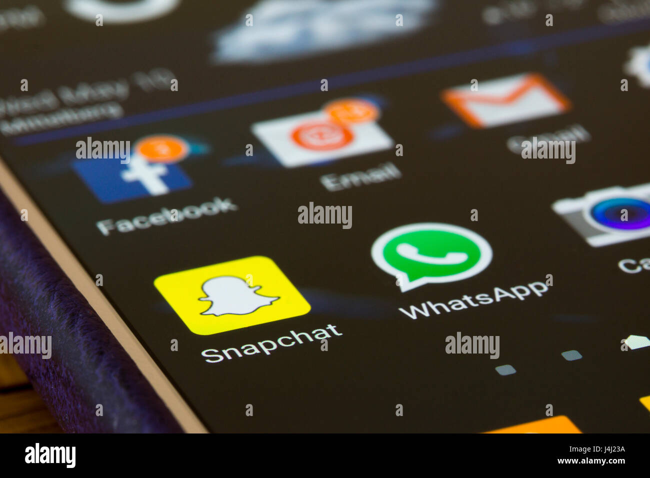 A closeup on a smartphone screen focused on the Snapchat app Stock ...