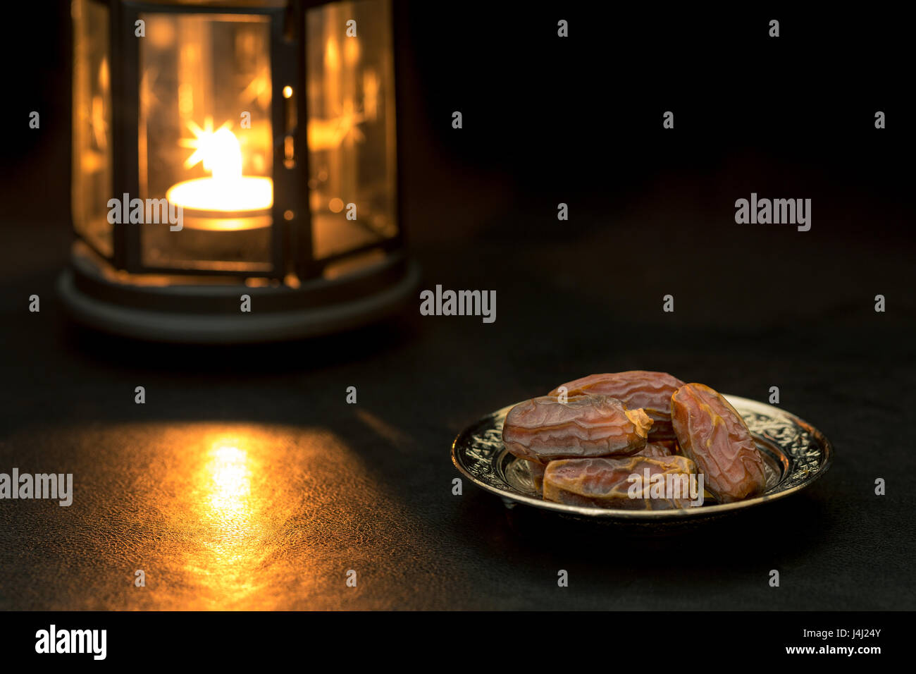 Dates with lantern background with yellow light Stock Photo - Alamy