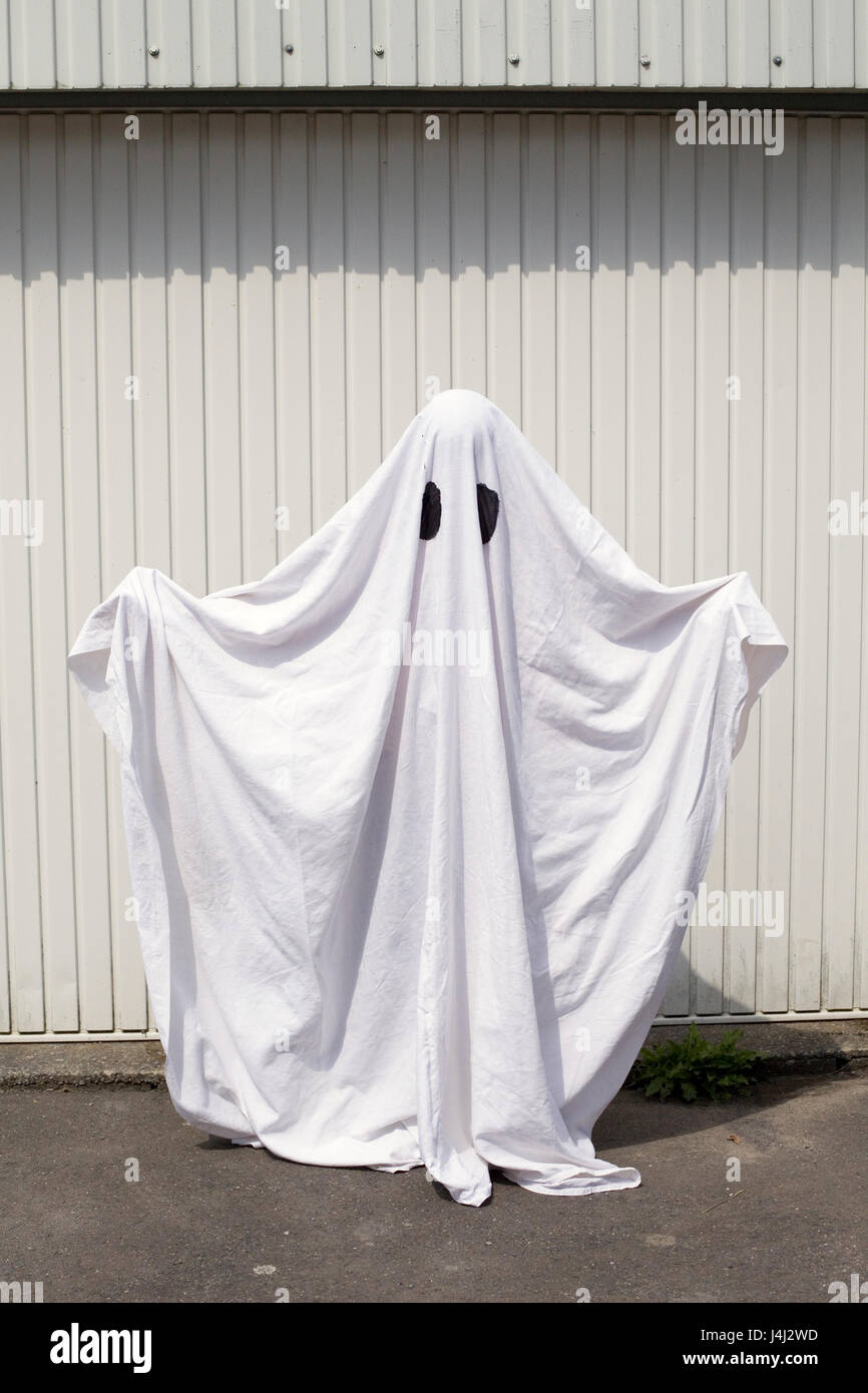 A white ghost in front of a garage door Stock Photo - Alamy