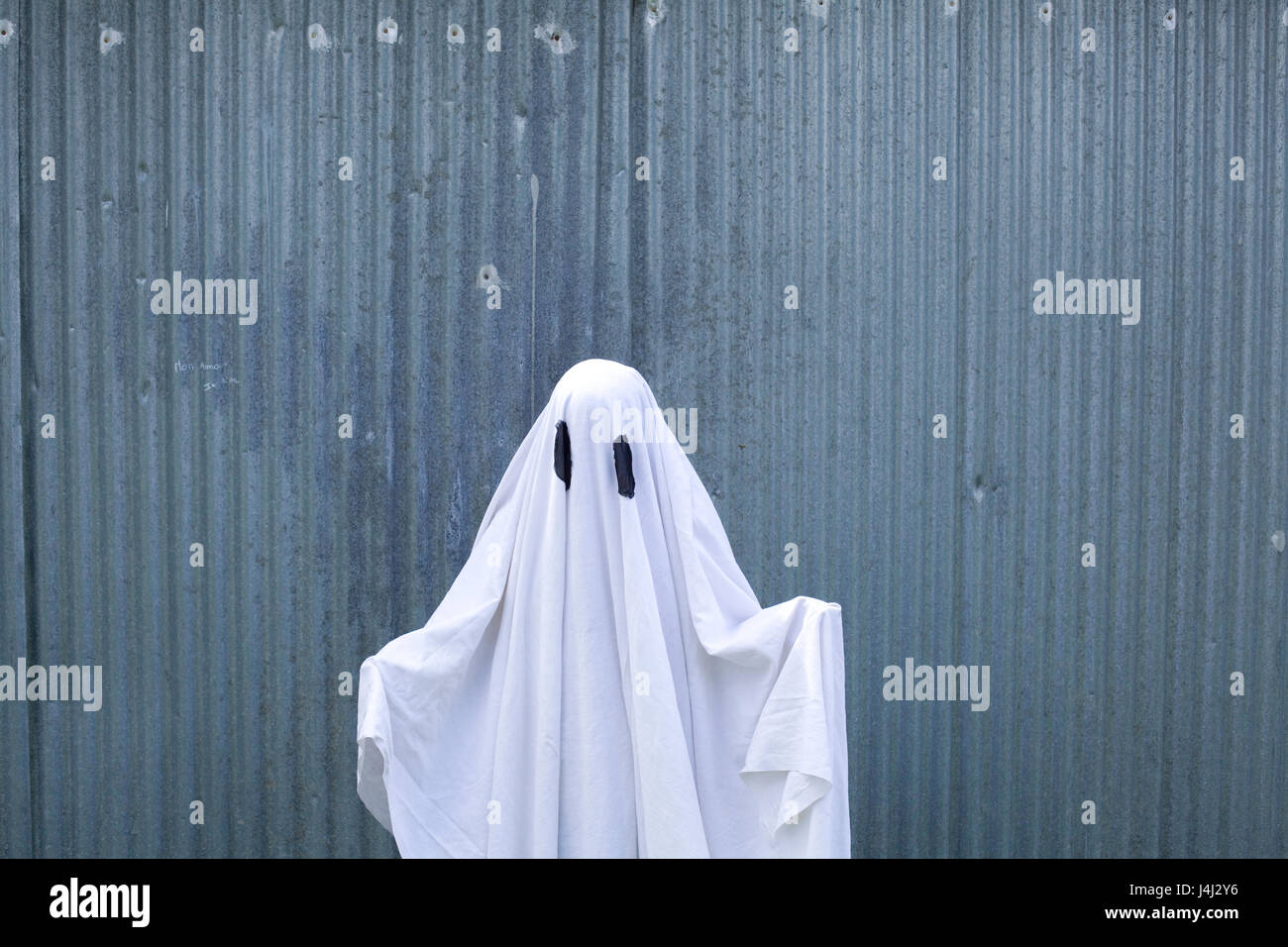 A white ghost in front of a garage door Stock Photo - Alamy