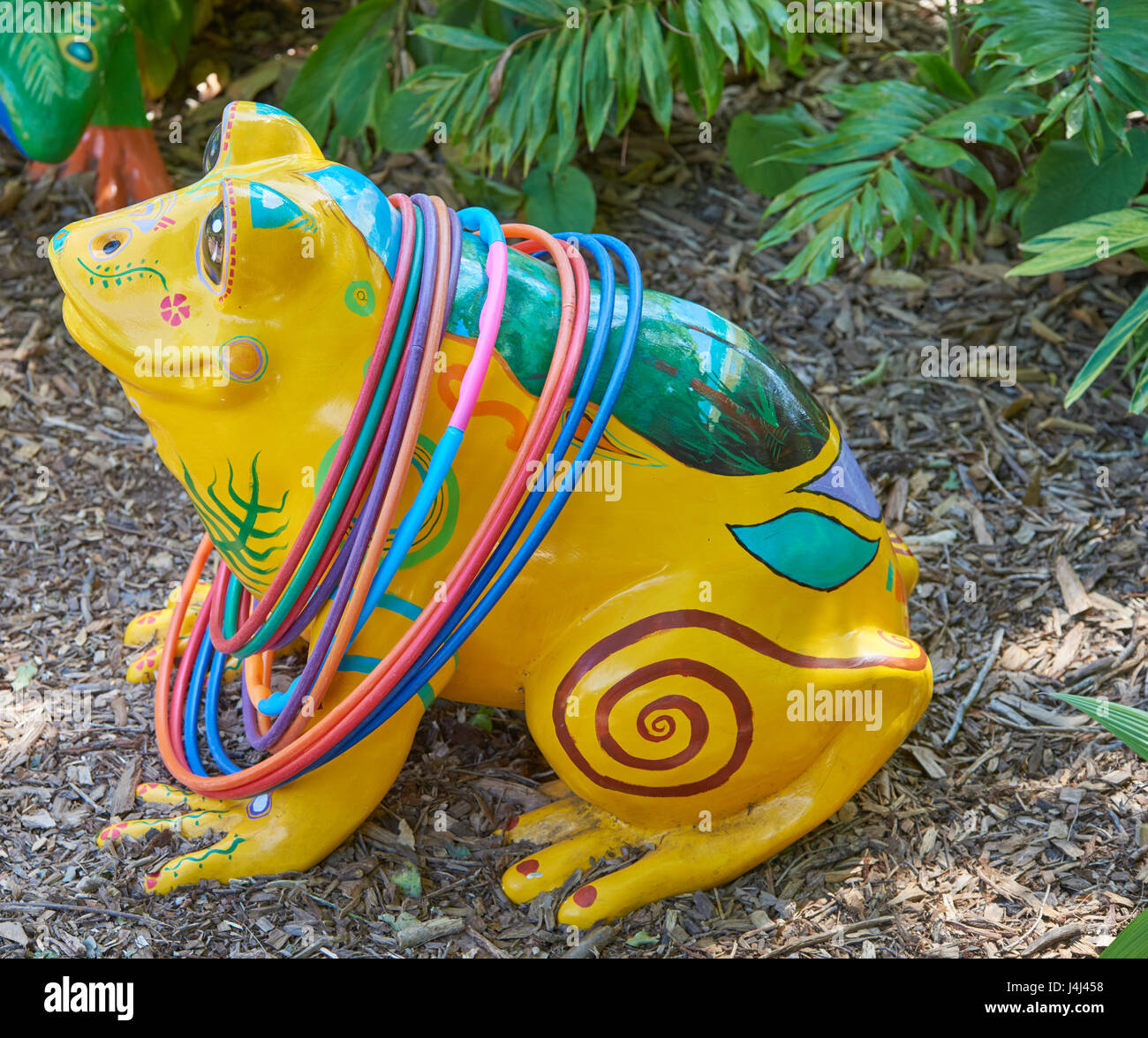 coloful cement frog with hula-hoops for kids play Stock Photo - Alamy