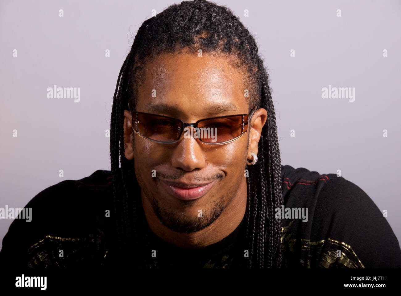 Young black man with braids in a studio - head shot Stock Photo - Alamy