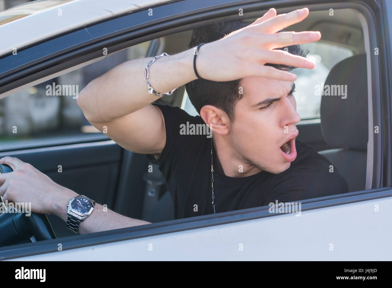 Angry Young Man Driving a Car and Yelling at People Stock Photo - Alamy