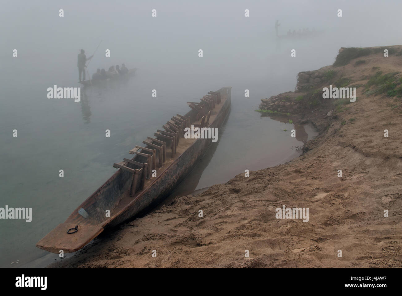 National wooden Nepalese canoe with inverted cisterns stands by the ...