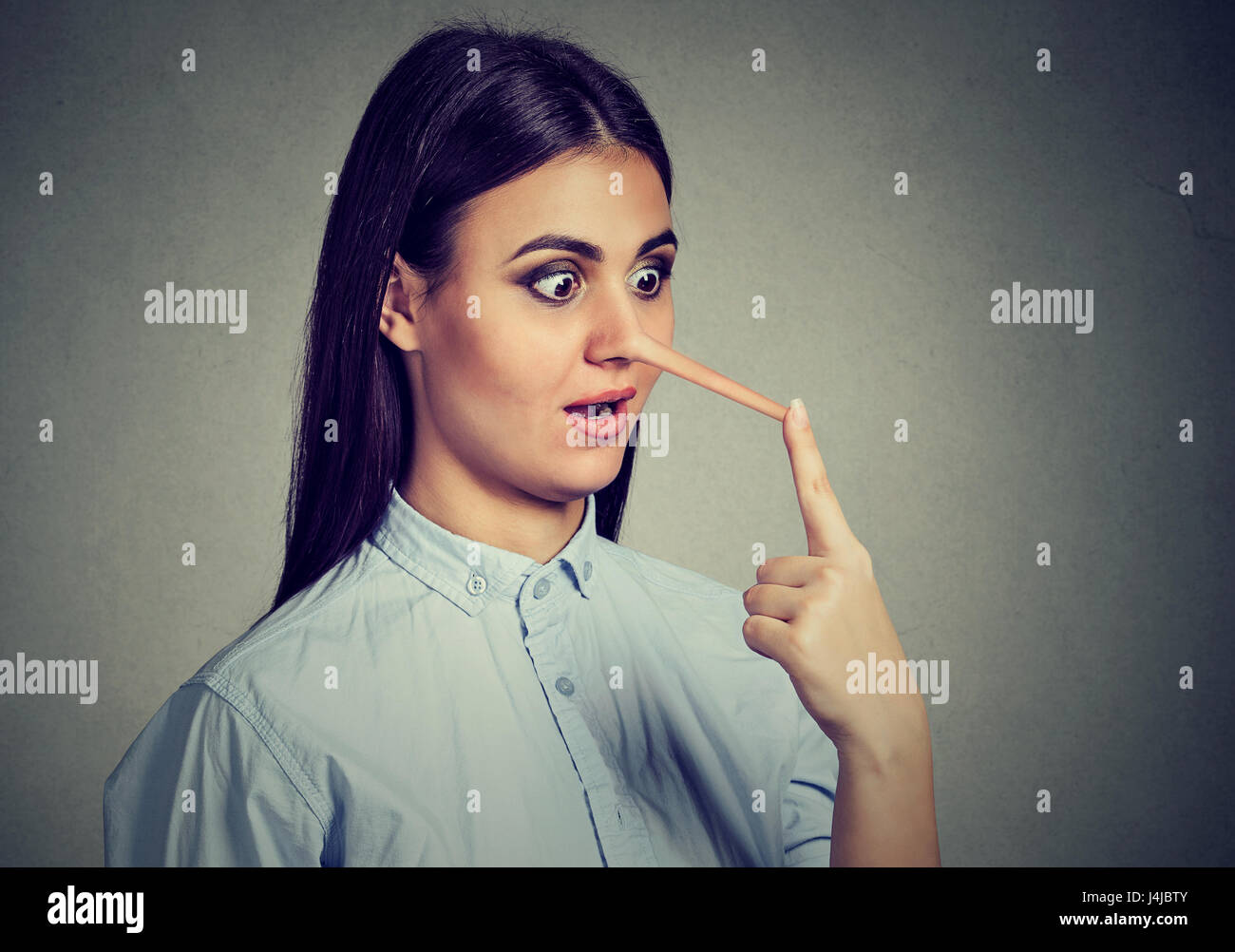 Liar woman with long nose isolated on gray wall background Stock Photo ...
