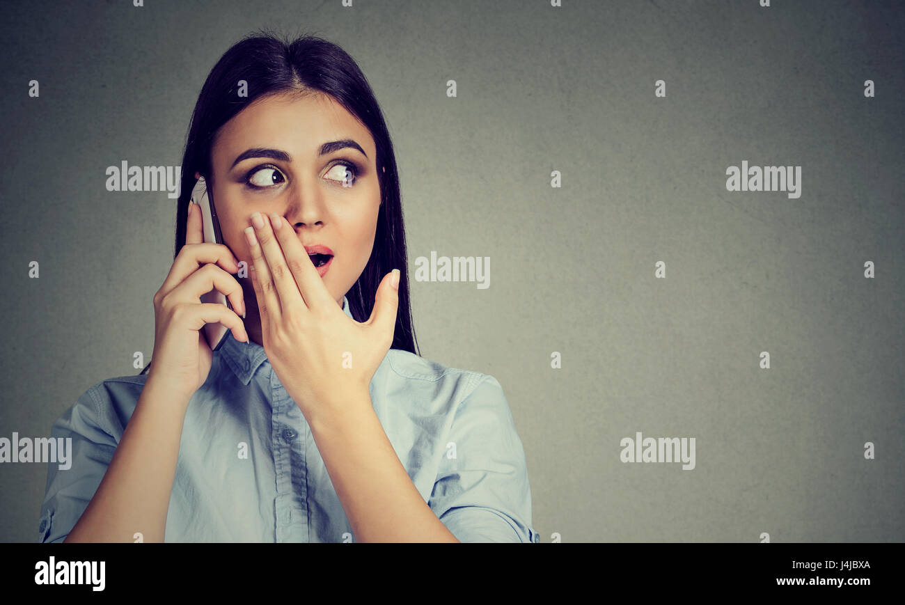 amazed shocked woman talking on mobile phone Stock Photo - Alamy