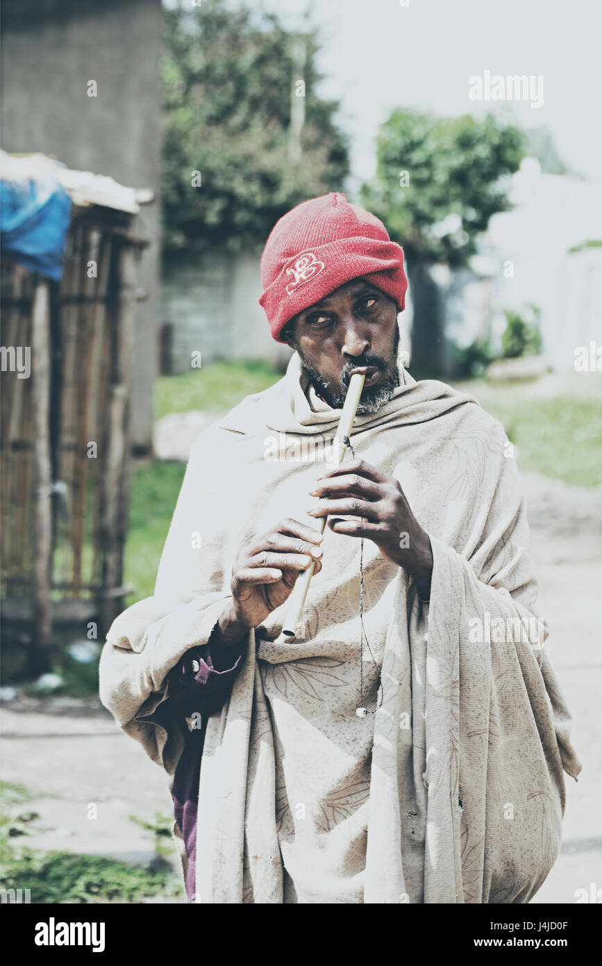 Ethiopian poor flute player playing flute on streets of Addis Ababa ...