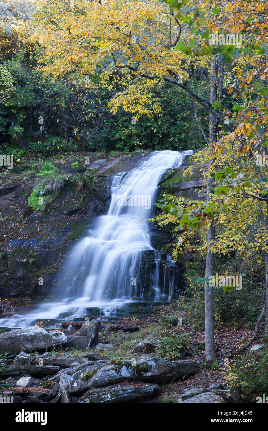 Brilliant fall foliage surrounds soft flowing waterfall Stock Photo - Alamy
