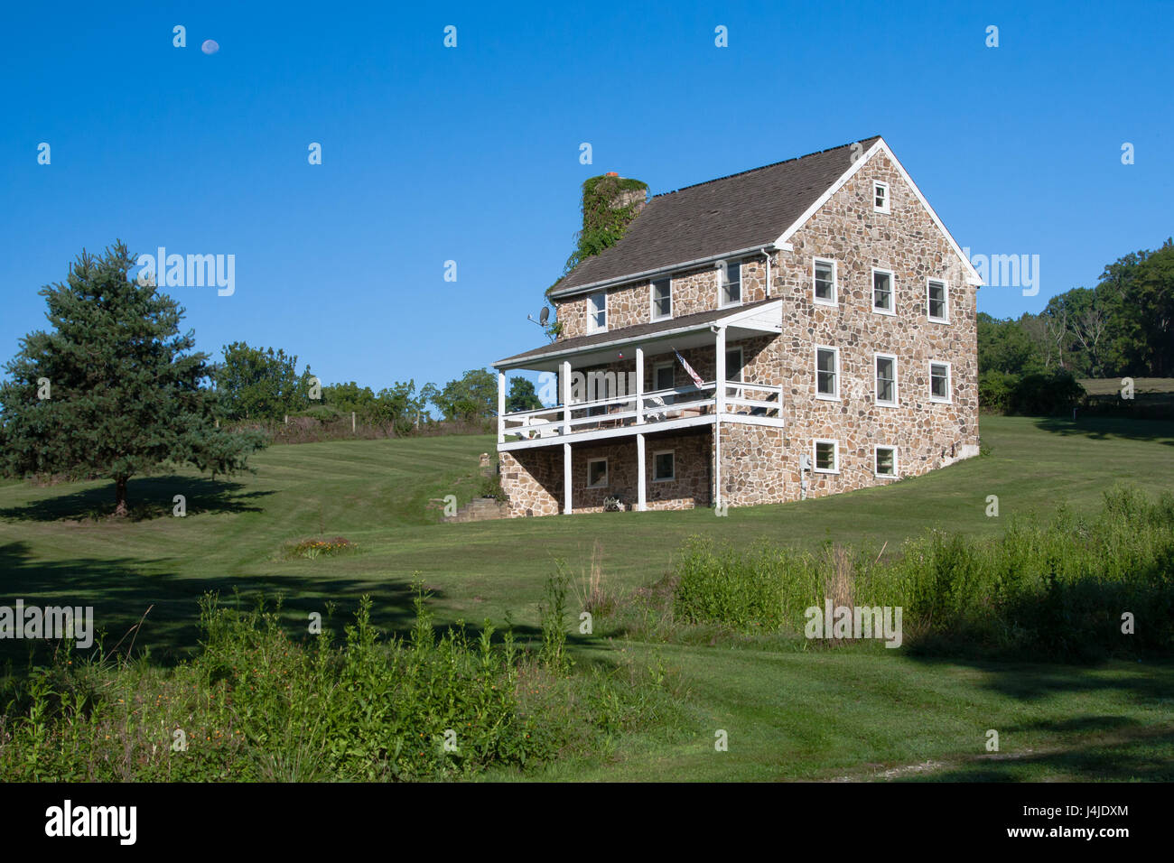 Colonial stone three story farm house Stock Photo - Alamy