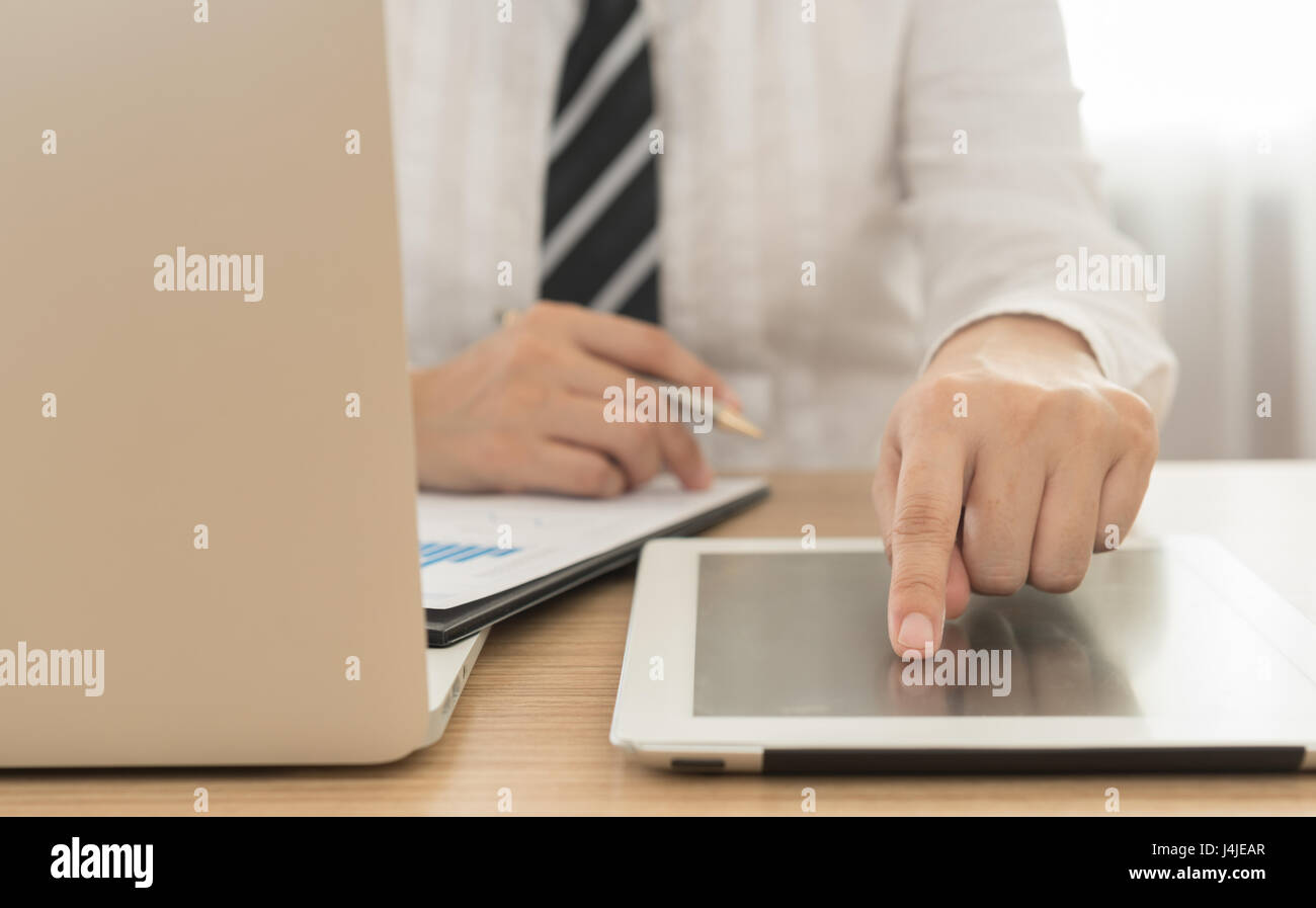 close up businessman's fingers touching the screen tablet computer ...
