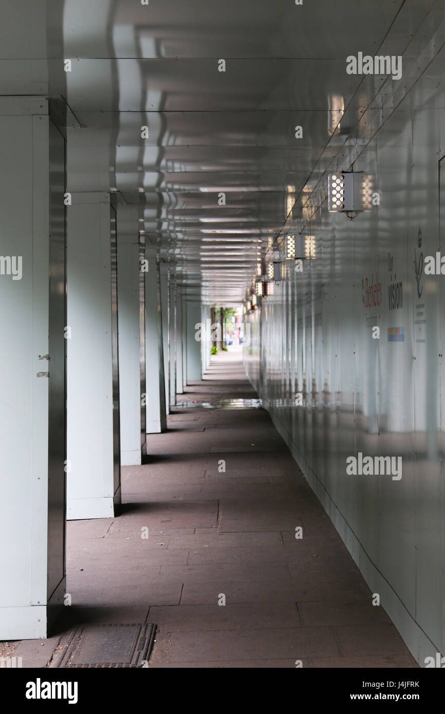 View down a pedestrian path through building works Stock Photo - Alamy
