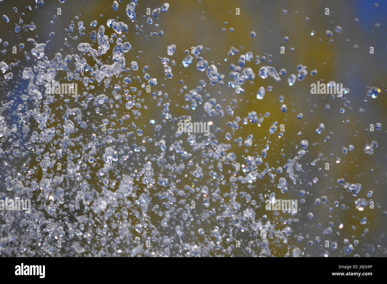 water drops from fountain in motion on the colorful backgruond - water ...
