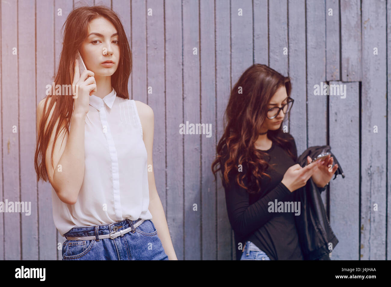 stylish young model walk in the street and pose for a photo on a Sunny ...