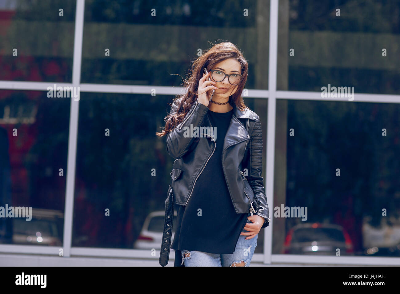 stylish young model walk in the street and pose for a photo on a Sunny ...