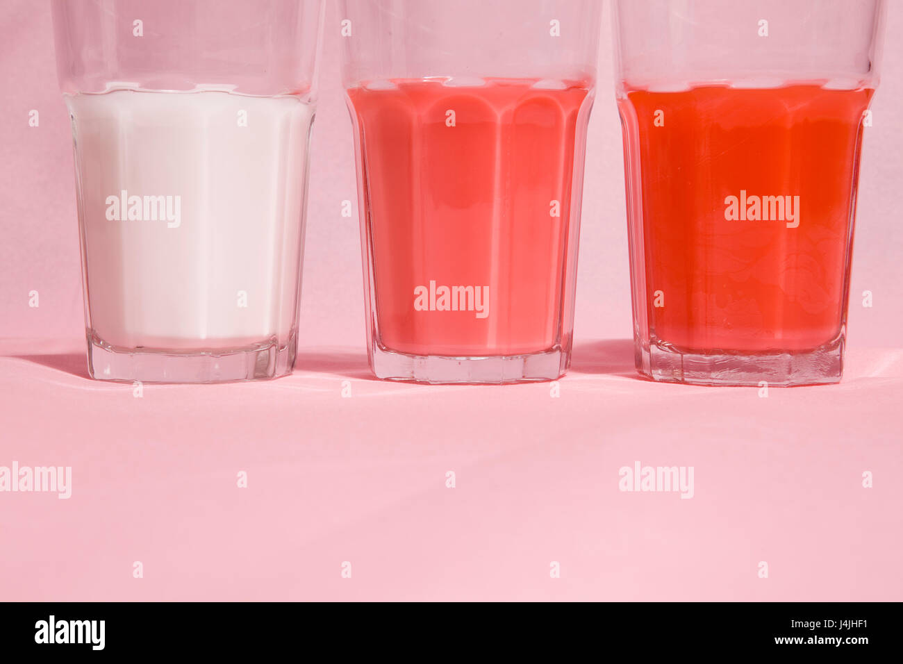 set of gradient cocktail in beer glasses on a pink background Stock ...
