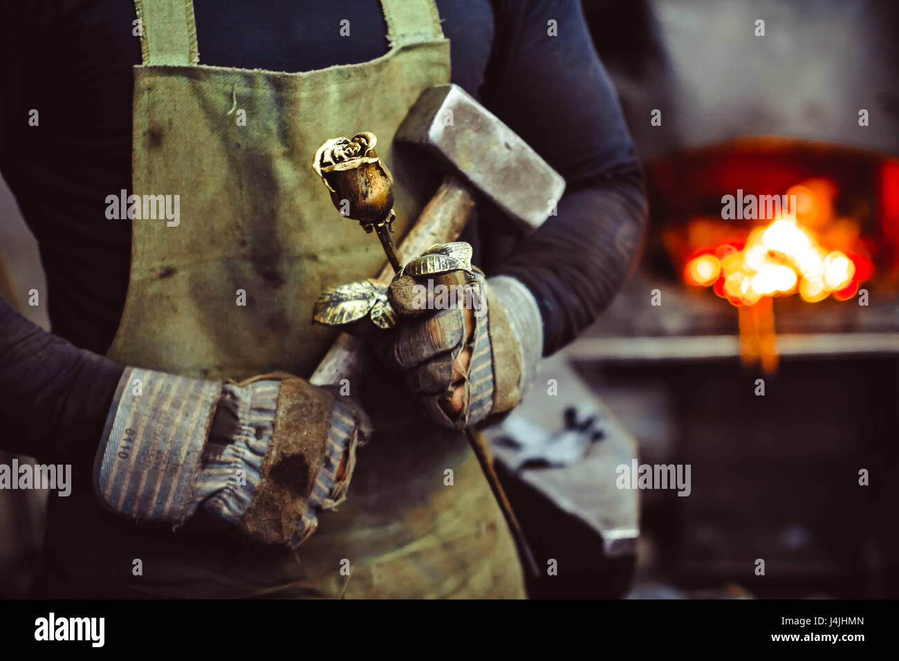Blacksmith holding forged rose Stock Photo - Alamy