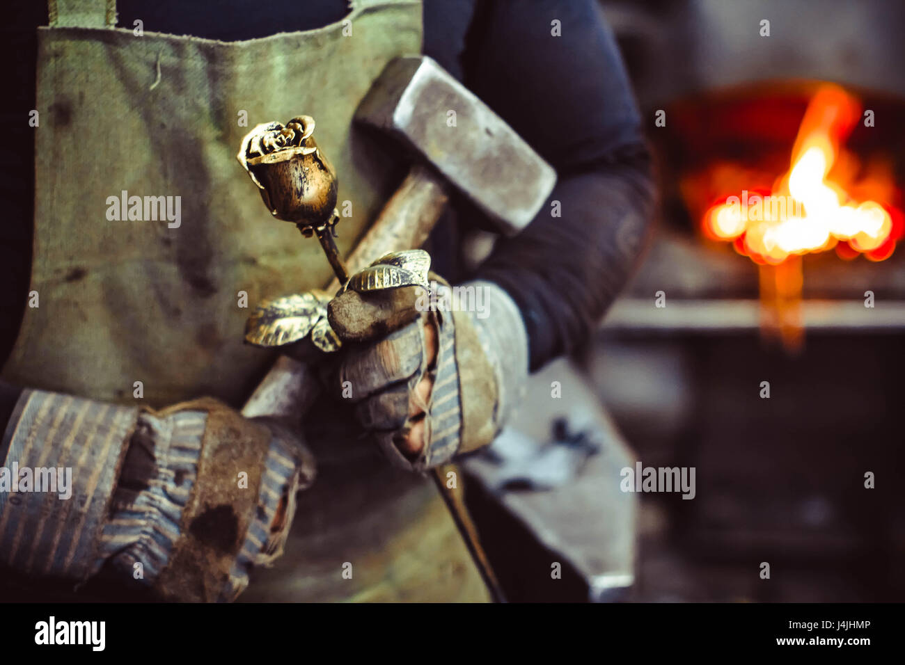Blacksmith holding forged rose Stock Photo - Alamy