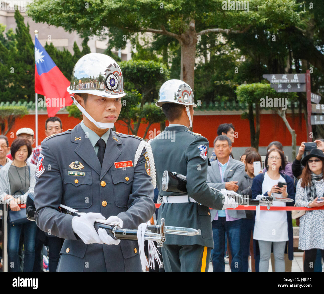TAIPEI, TAIWAN: Ceremonial guard with rifle and bayonet with tourist in the background at ...