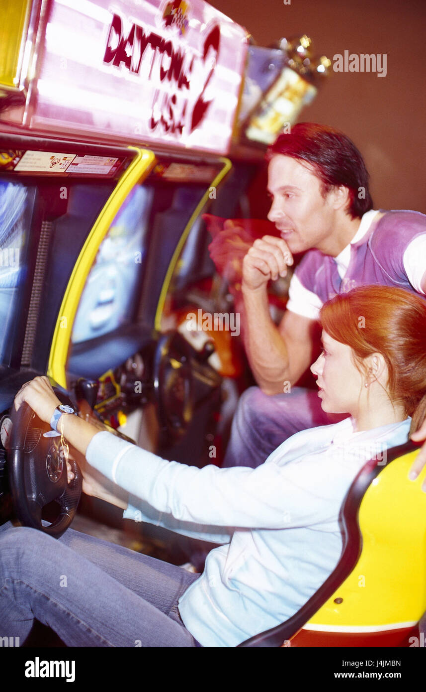 Amusement arcade, couple, young, video game, at the side, blur game ...