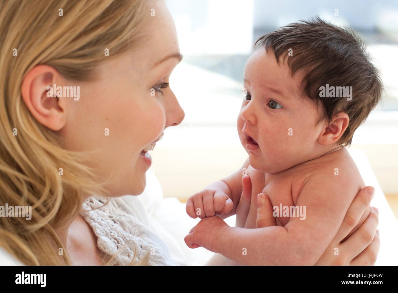 Mother holding newborn baby girl Stock Photo - Alamy