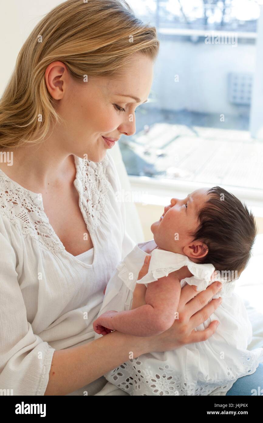 Mother holding newborn baby girl Stock Photo - Alamy