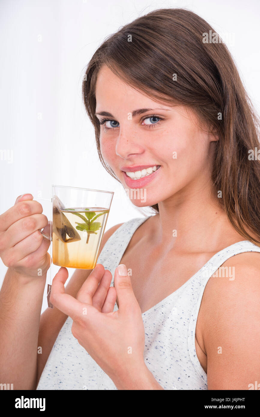 Young woman drinking herbal tea Stock Photo - Alamy
