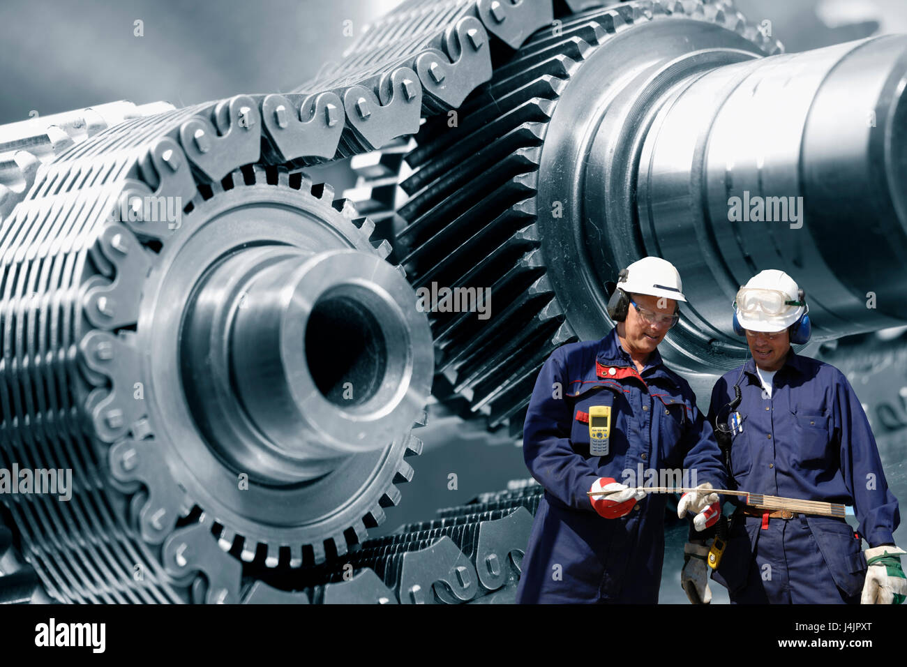 Industrial workers with machine and metal cogs Stock Photo - Alamy