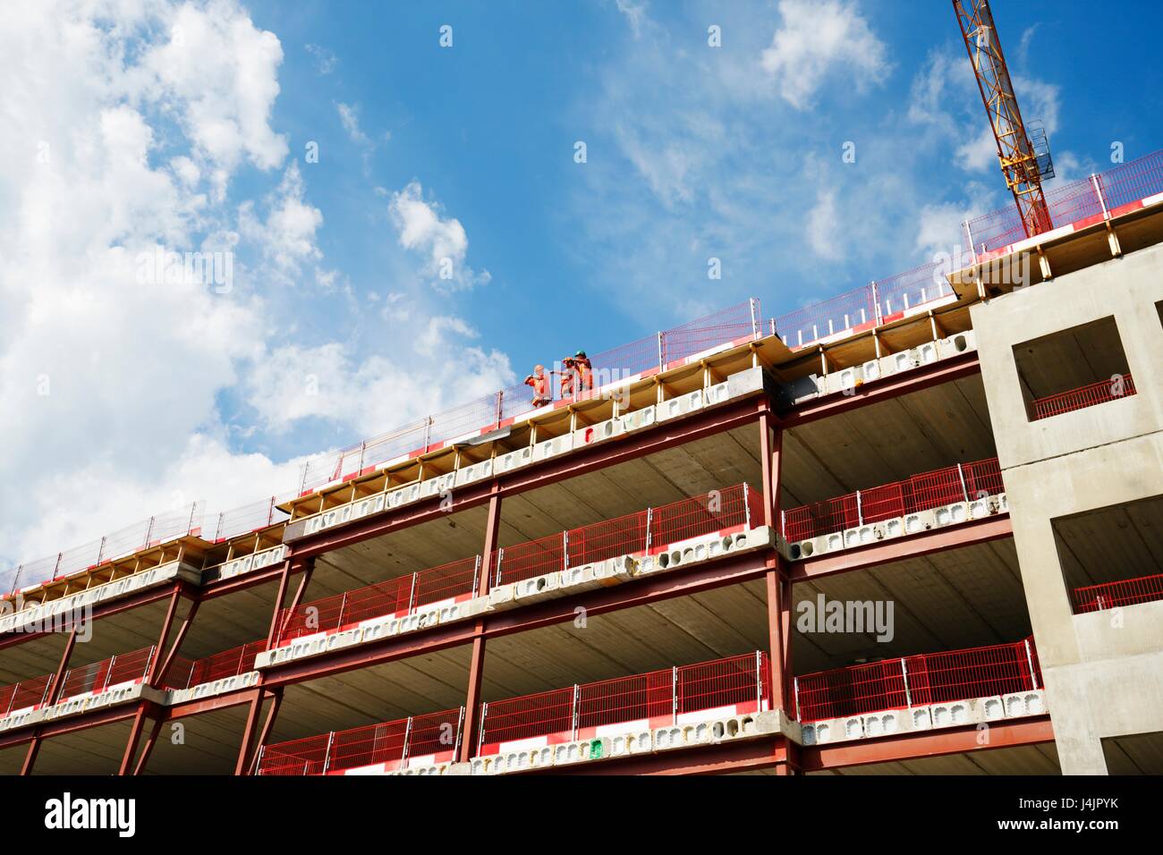 Construction workers on top of incomplete building Stock Photo - Alamy