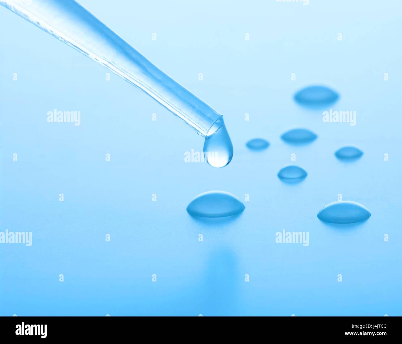 Water droplets dripping from a pipette, studio shot Stock Photo - Alamy