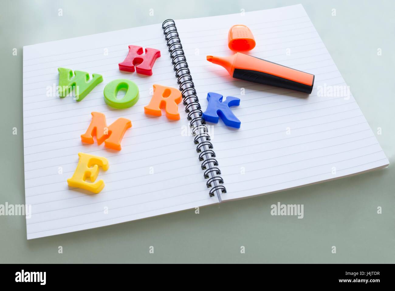 Colourful letters on notebook spelling homework Stock Photo - Alamy