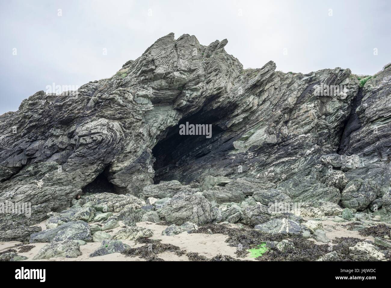 Folded rock rock strata and cave at Porth Dafarch, Anglesey, Wales, UK ...