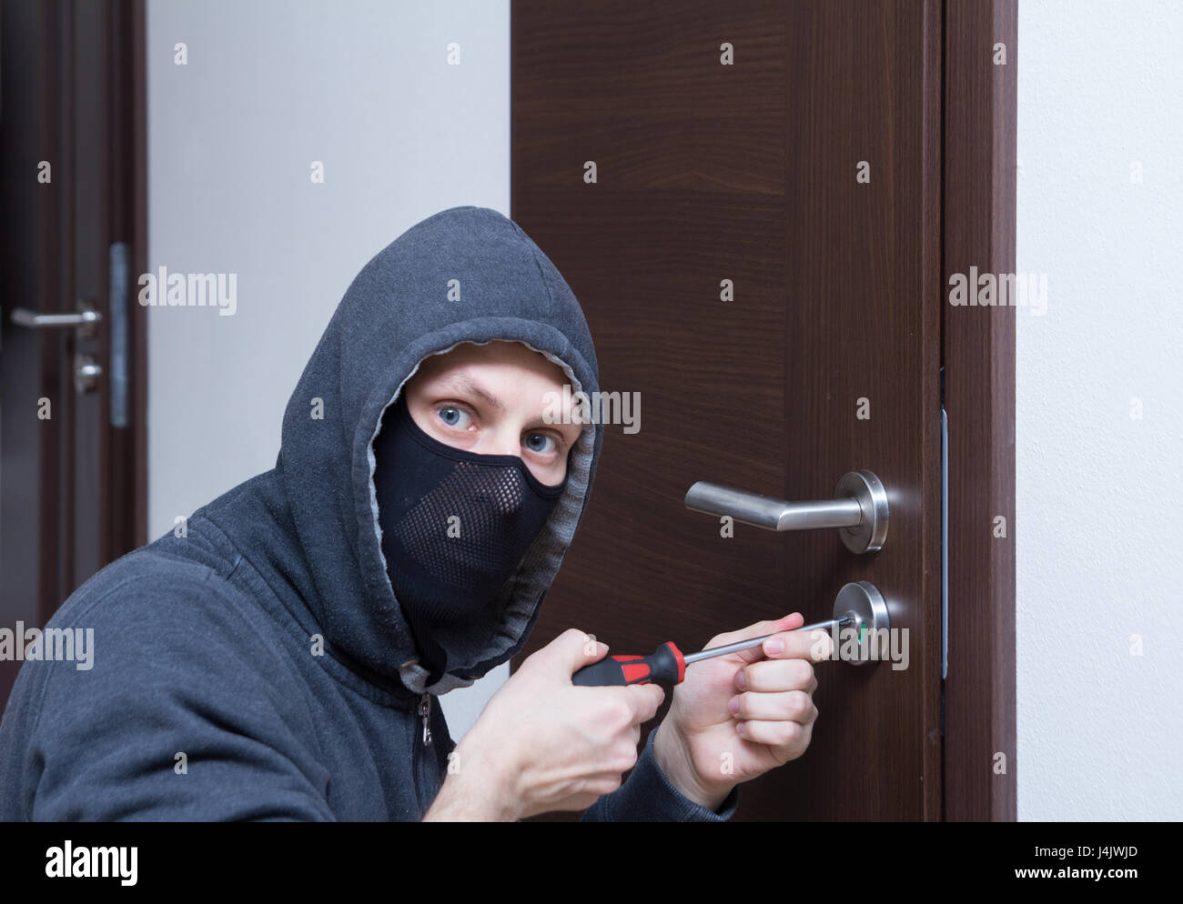 thief opening lock on door Stock Photo - Alamy