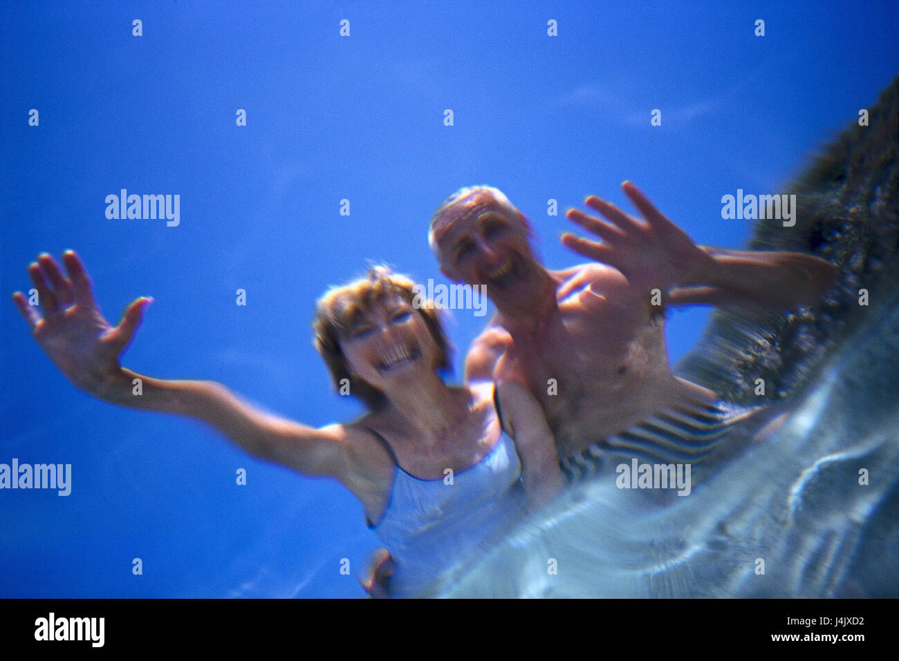 Underwater recording, water surface, couple, pool margin under water ...