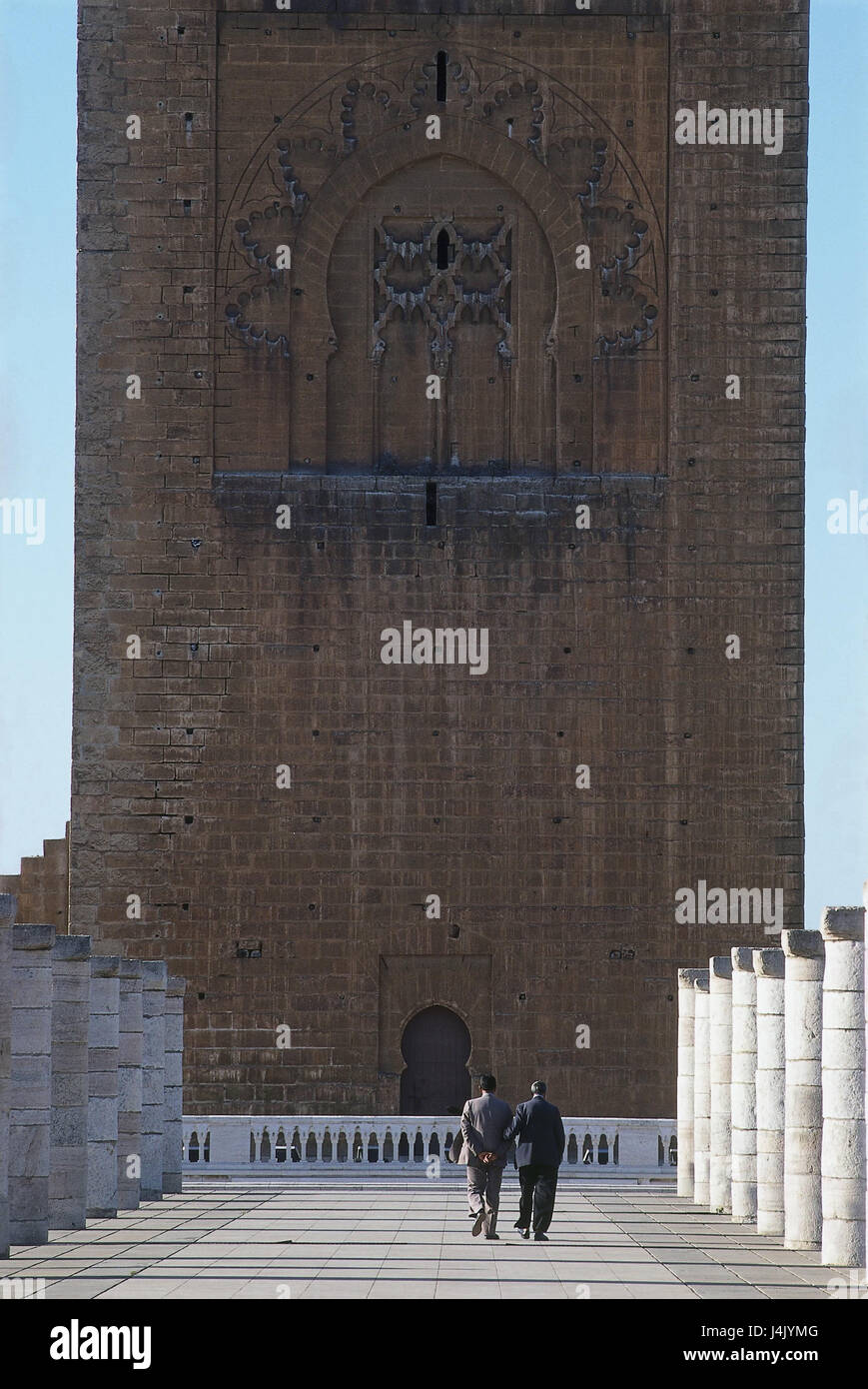 Morocco, Rabat, Hassan tower, detail, men, back view, no model release ...