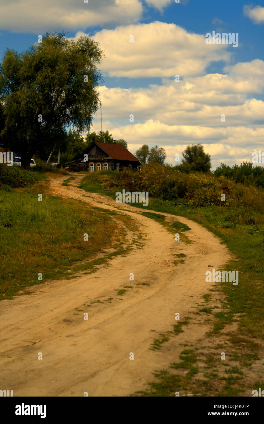 Rural road and Russian hut in summer. Landscape of the middle belt of ...