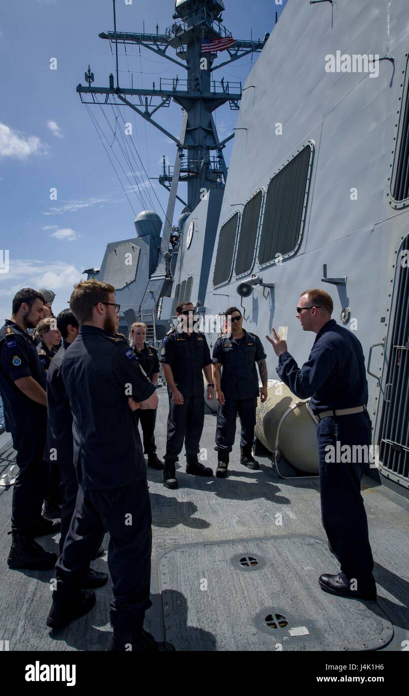 Royal New Zealand Navy sailors receive a tour of the aft missile deck ...