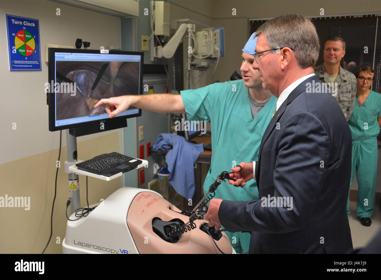 Secretary of Defense Ash Carter steadies his hand using the Laparoscopy ...