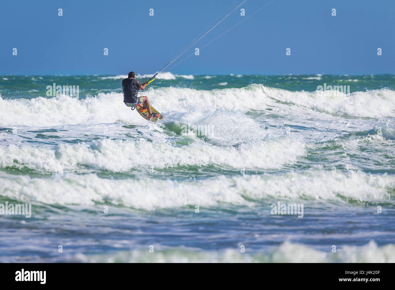 Kitesurfer riding on waves hi-res stock photography and images - Alamy