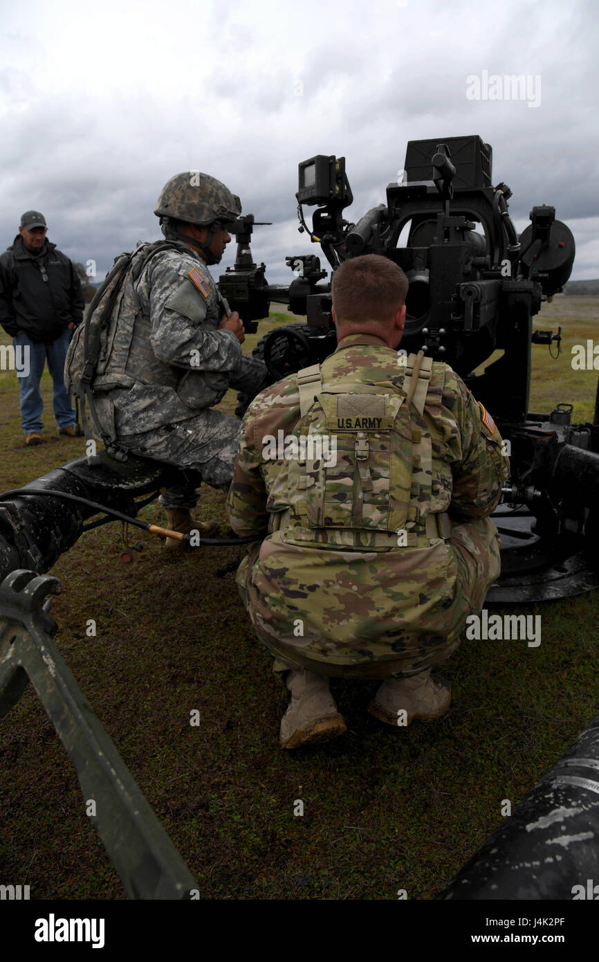 Alpha and Bravo Battery, 1-143rd Field Artillery, prepare an M119A3 105mm Howitzer at Camp ...