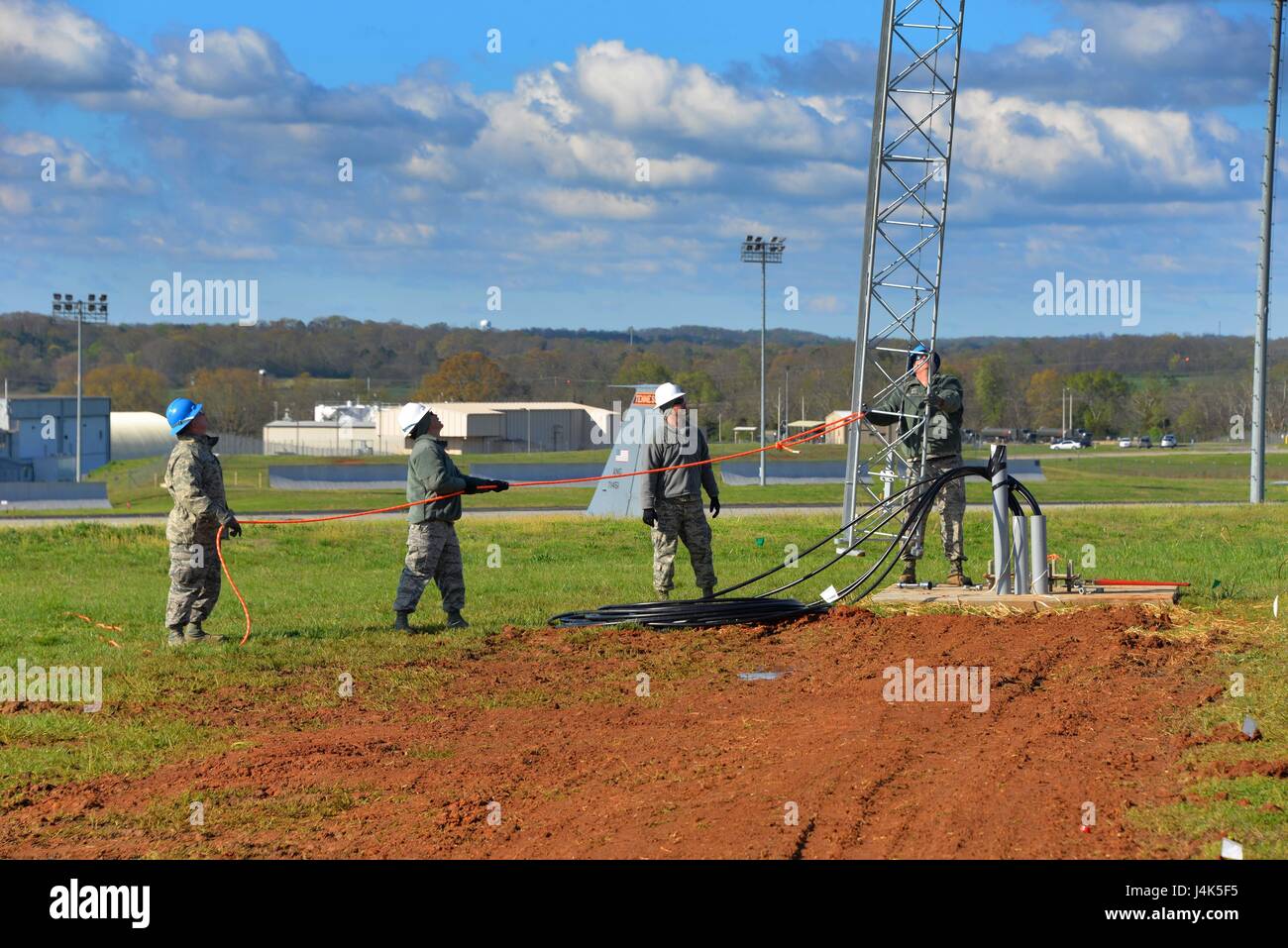 Members of the 241st Engineer Installation Squadron, help to erect a ...