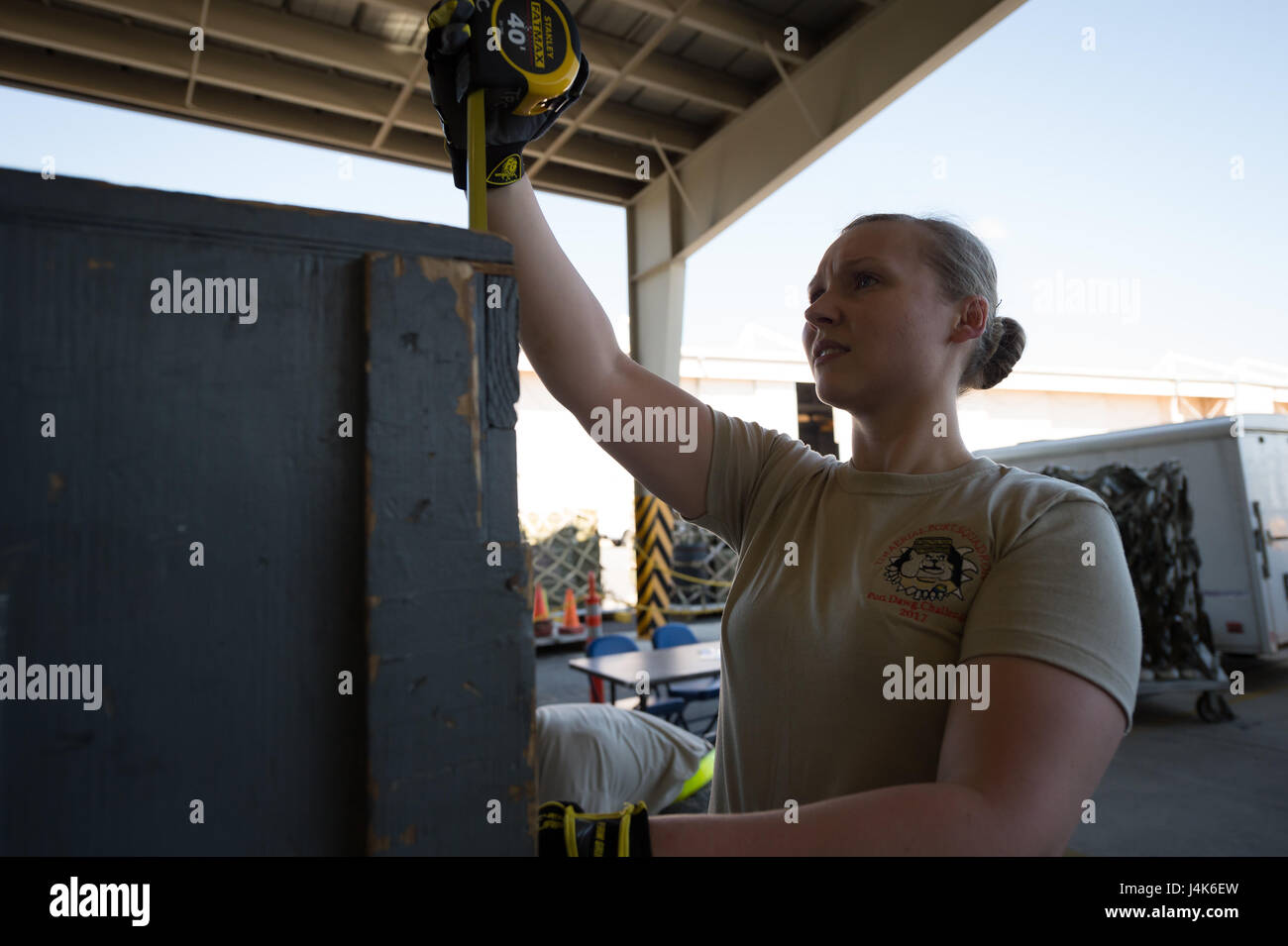 U.S. Air Force Senior Airman Liliya Kampsen measures the cargo ...