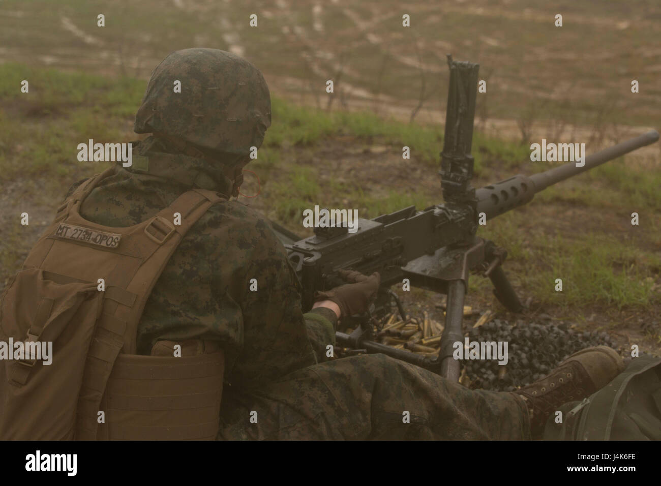 A Marine clears an M2 .50 caliber machine gun during a live-fire range ...