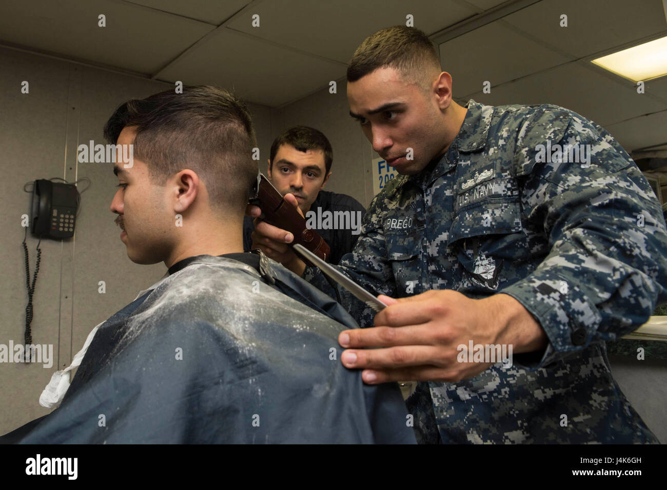 Sailors aboard USS Dwight D. Eisenhower (CVN 69) receive haircuts in ...