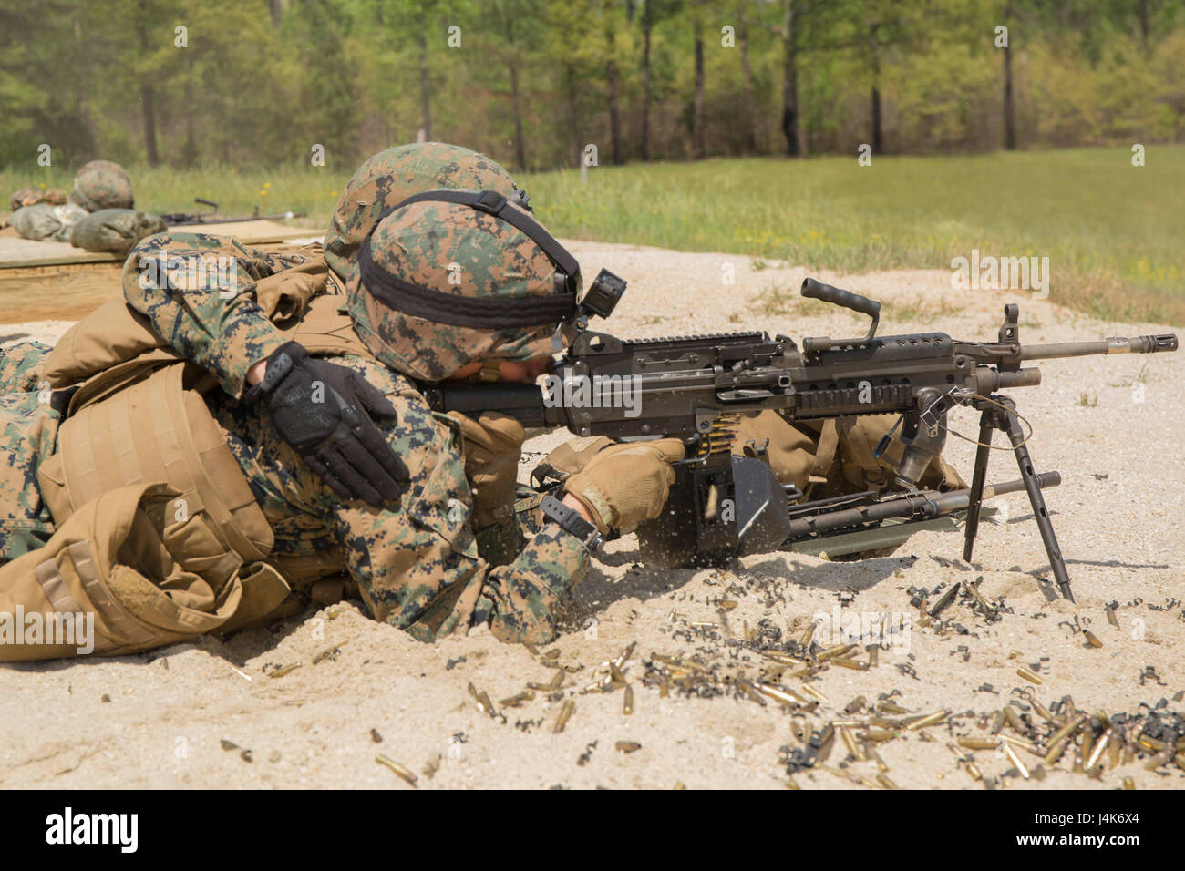 A Marine fires an M249 light machine gun during a machine gun course at ...